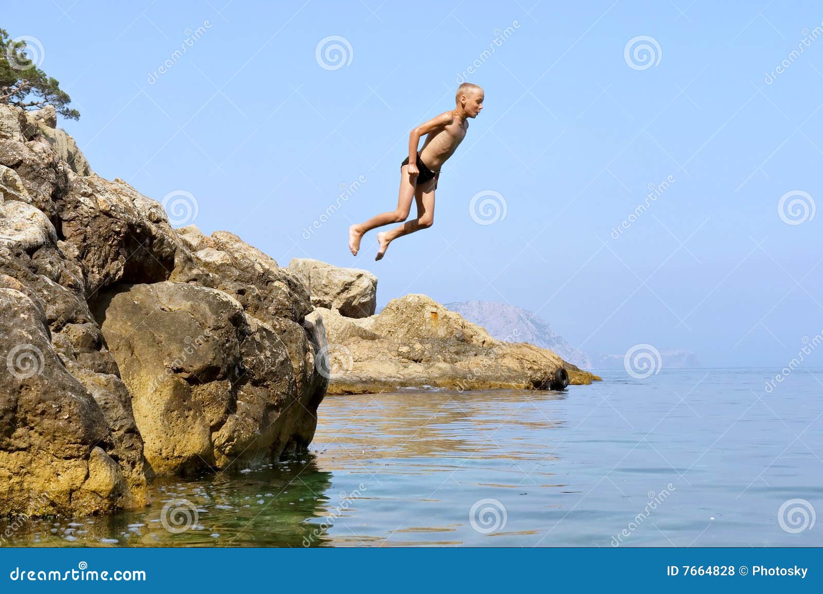 Happy Boy Jumps from Rock into Sea Stock Photo - Image of cape ...