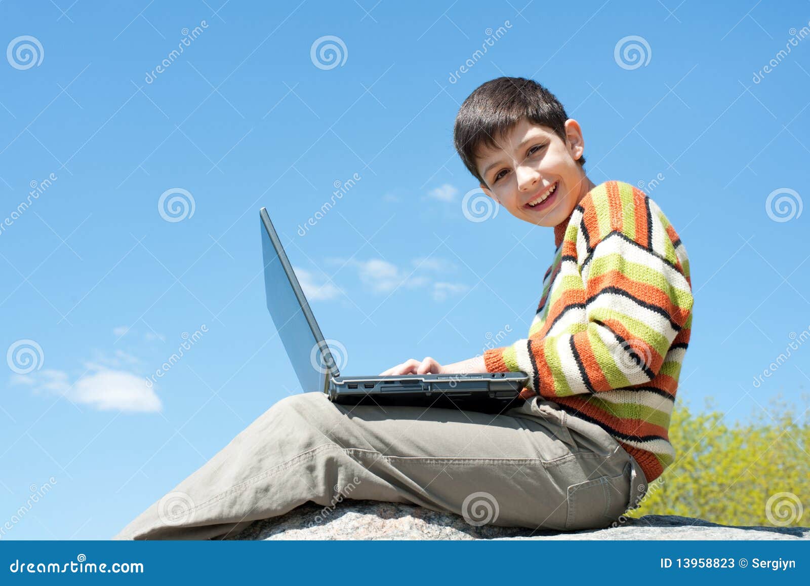 Happy boy with a laptop stock image. Image of ardour - 13958823