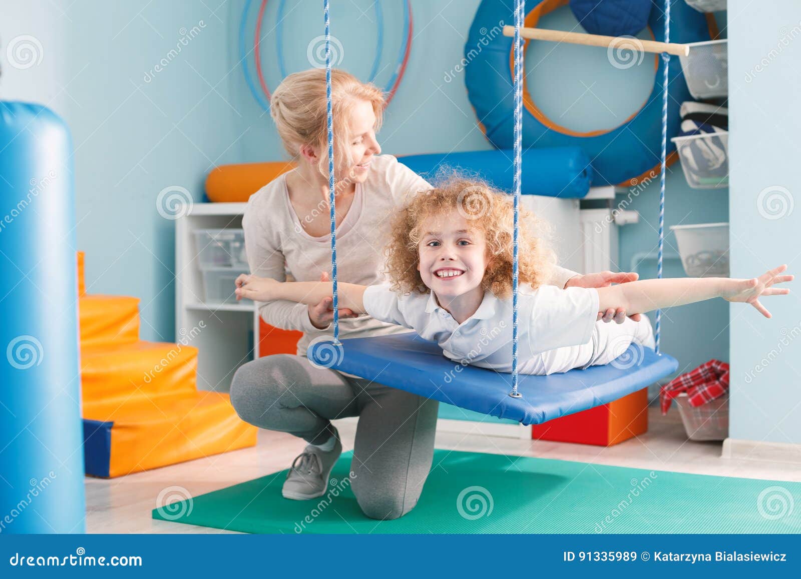 Happy boy lying on swing stock image. Image of equipment - 91335989