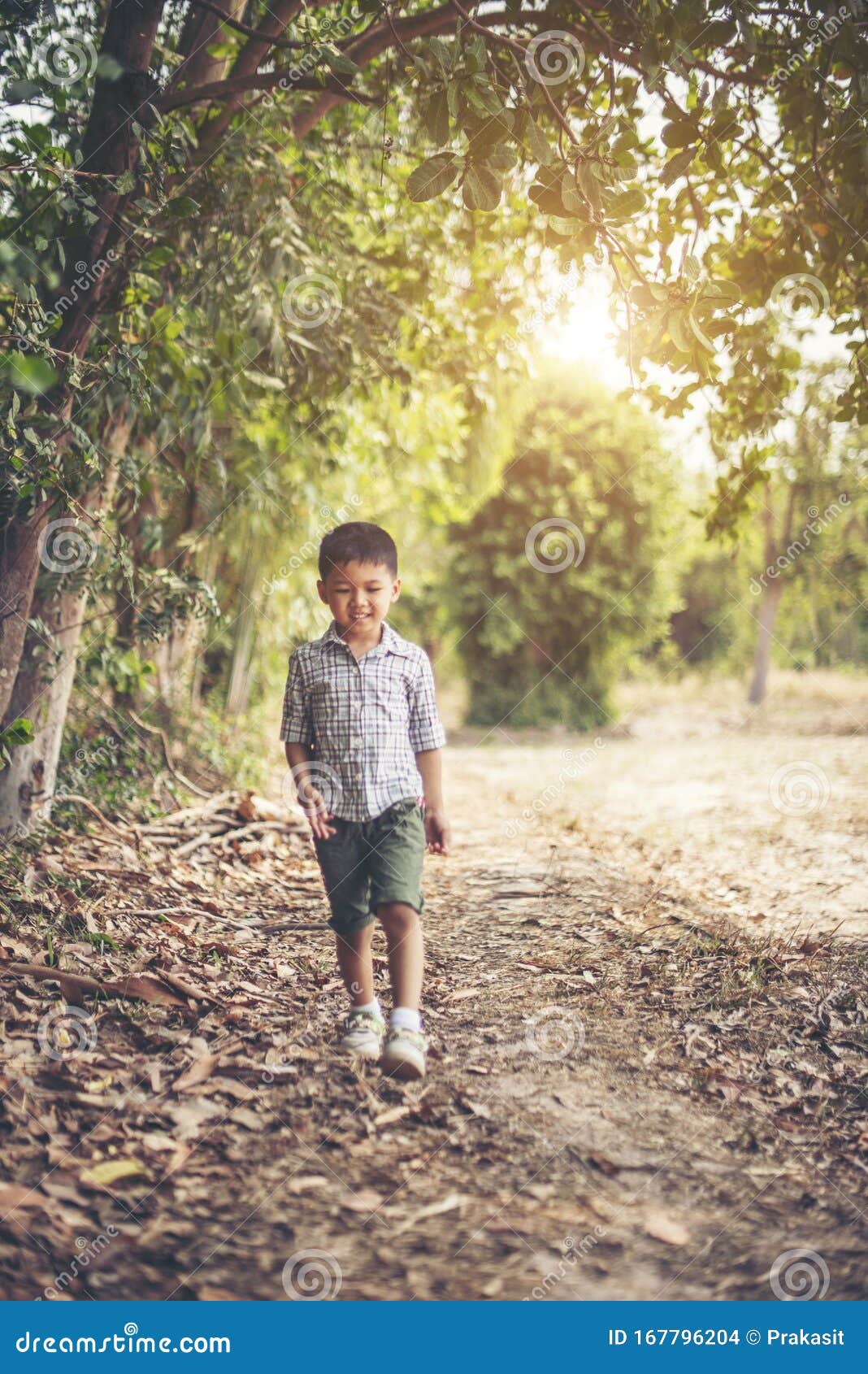 Happy boy playing alone stock photo. Image of field - 167796204