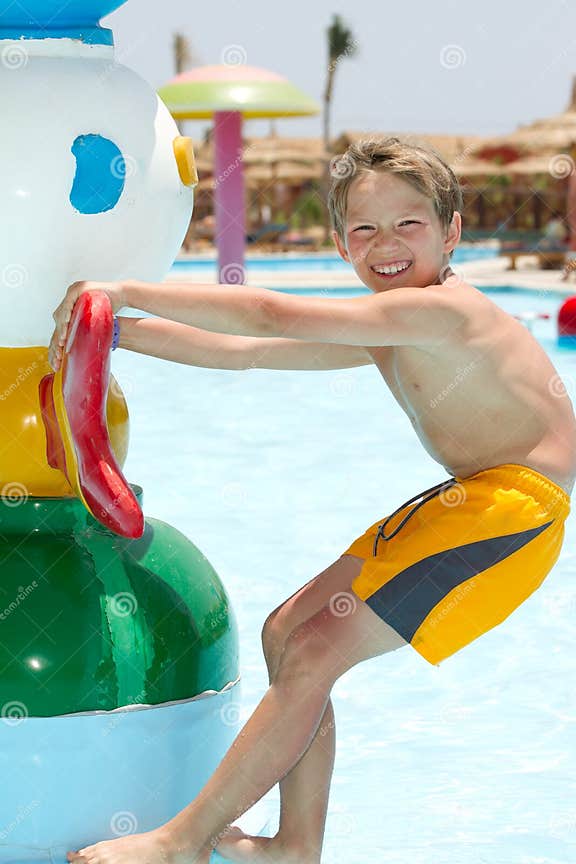 Happy boy playing in pool stock image. Image of youthful - 20340301