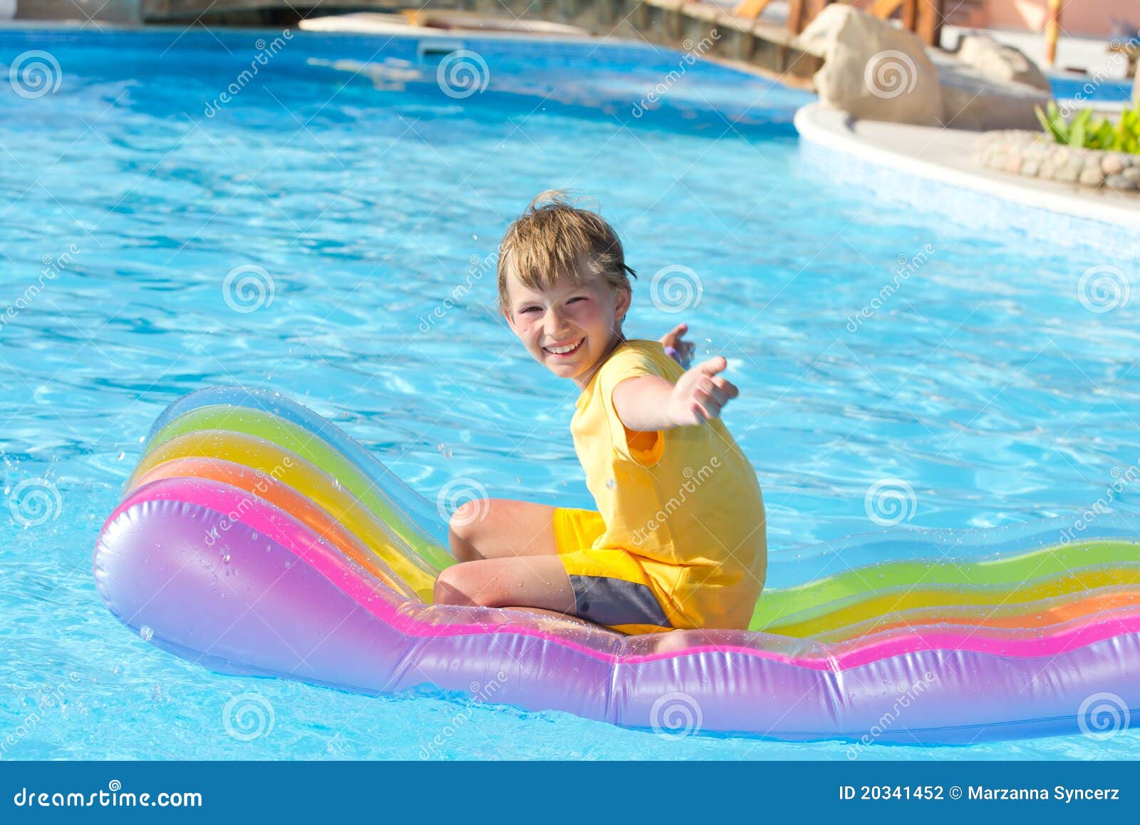 Happy boy playing in pool stock photo. Image of playful - 20341452