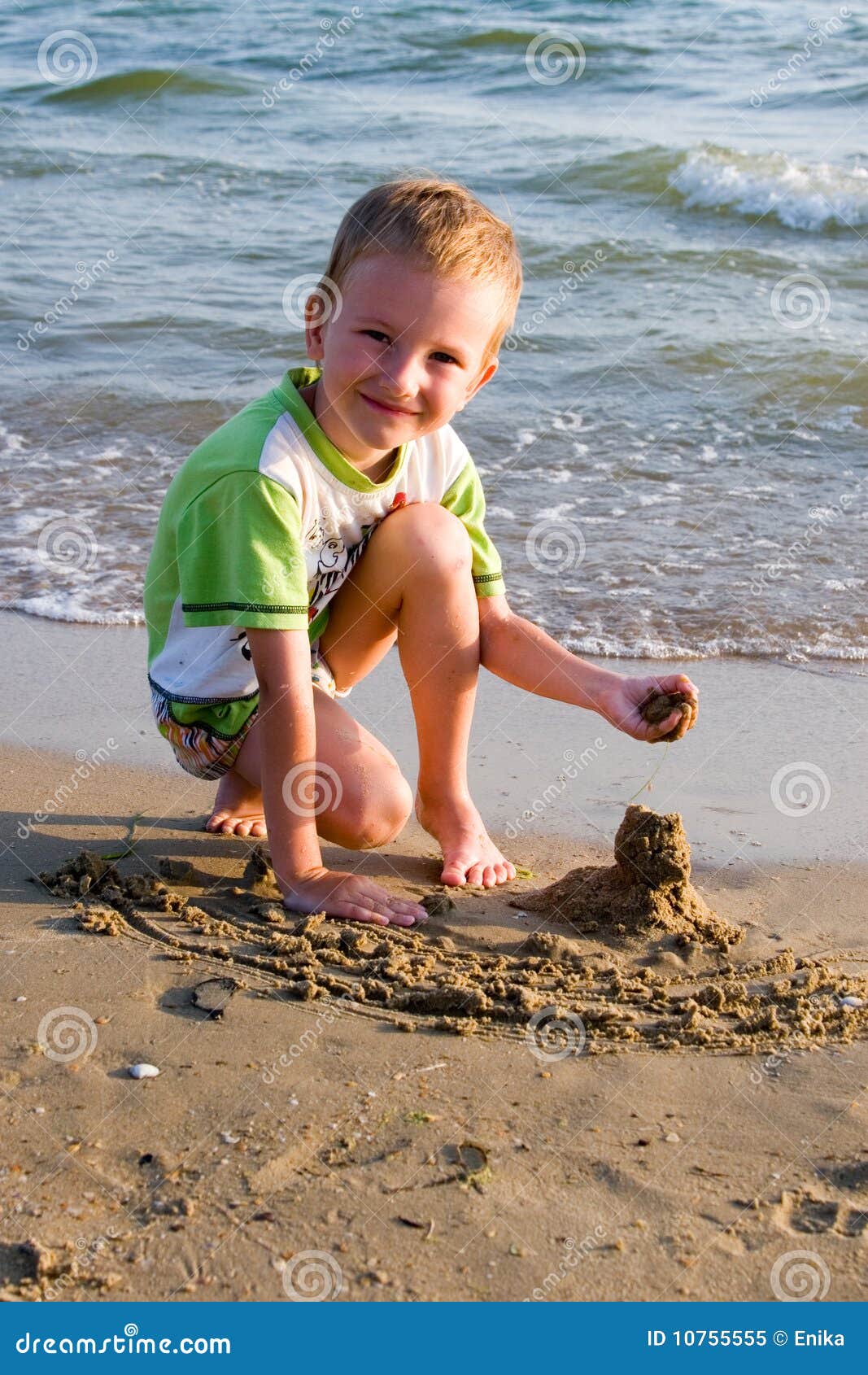 The happy boy plays sand stock image. Image of vacation - 10755555