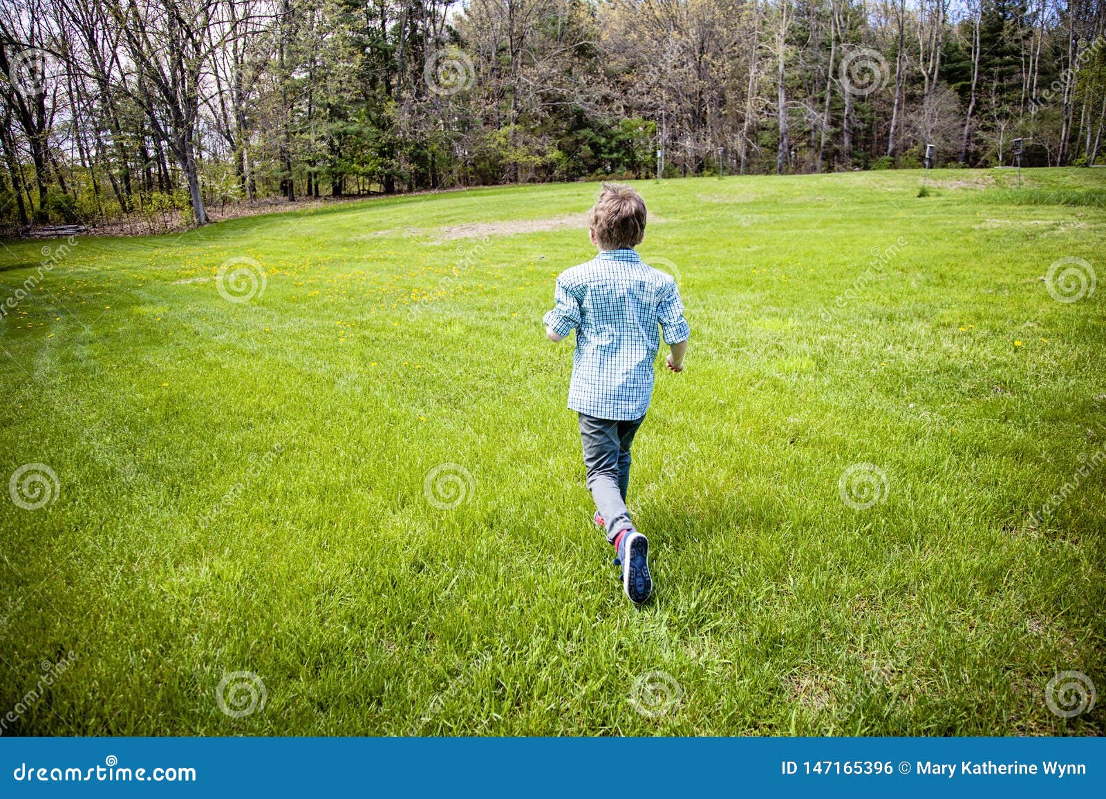 Happy boy running outside stock photo. Image of play - 147165396