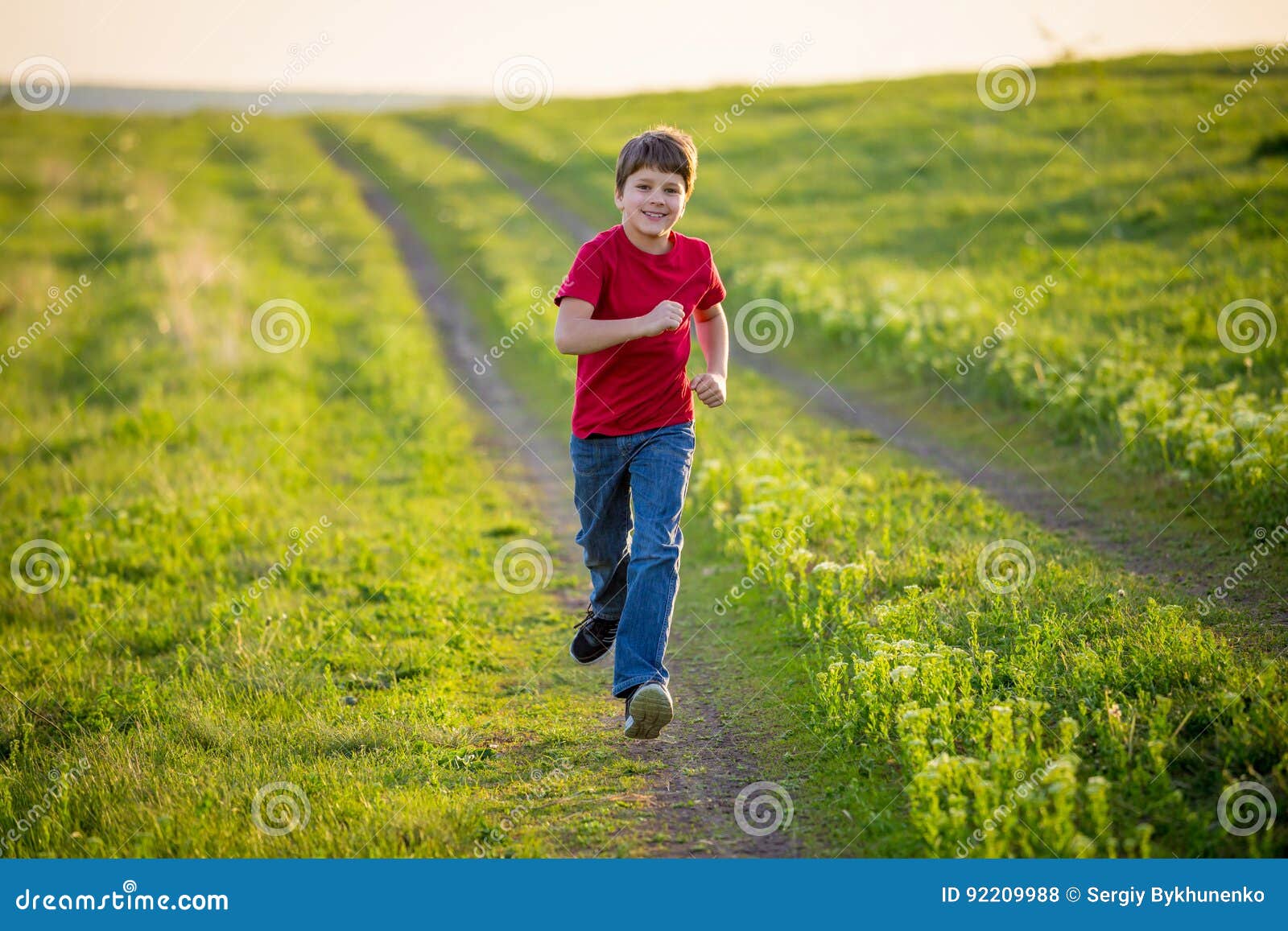 Happy Boy Running on Rural Road with Green Grass Stock Photo - Image of ...