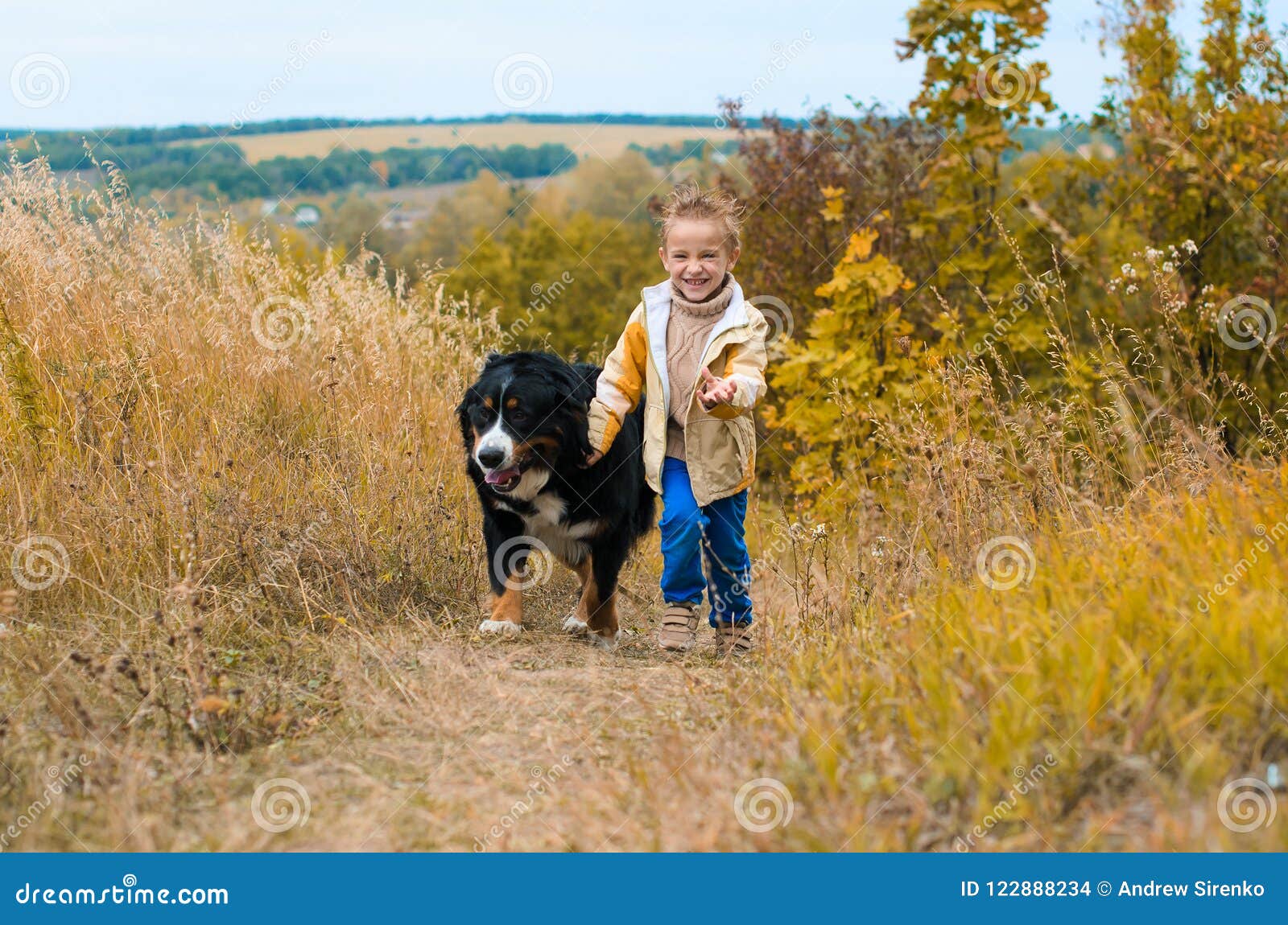 Happy Boy Runs Around with Big Dog on Autumn Hills of Race Stock Photo ... Happy Boy Runs Around with Big Dog on Autumn Hills of Race Stock Photo ...