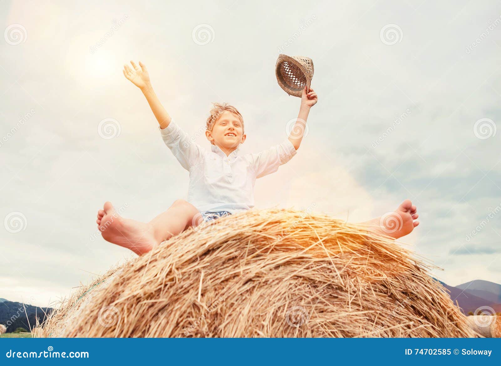 Happy Boy Sits Over Big Rolling Haystack Stock Image - Image of ...