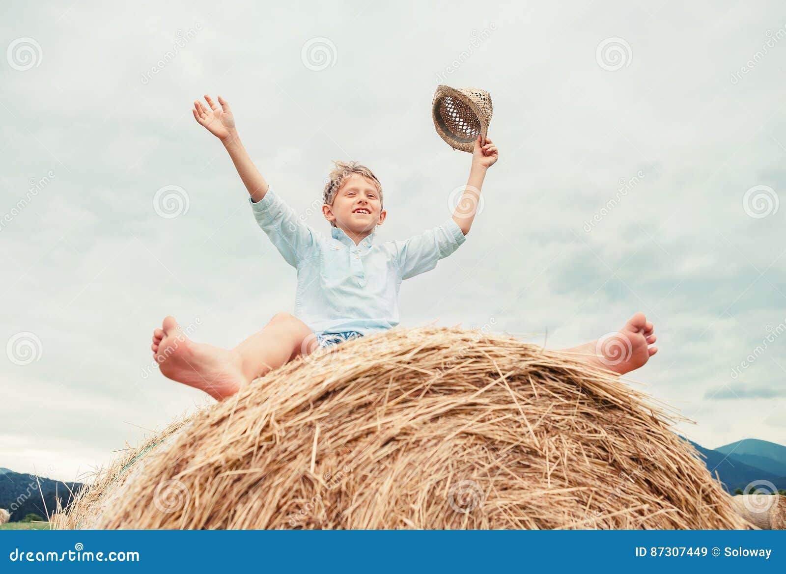 Happy Boy Sits Over Big Rolling Haystack Stock Image - Image of ...