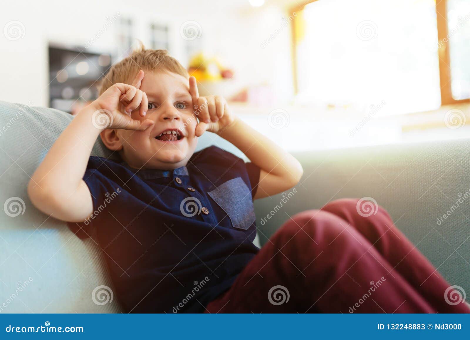 Happy Cute Boy Sitting on Sofa in Living Room Stock Image - Image of ...