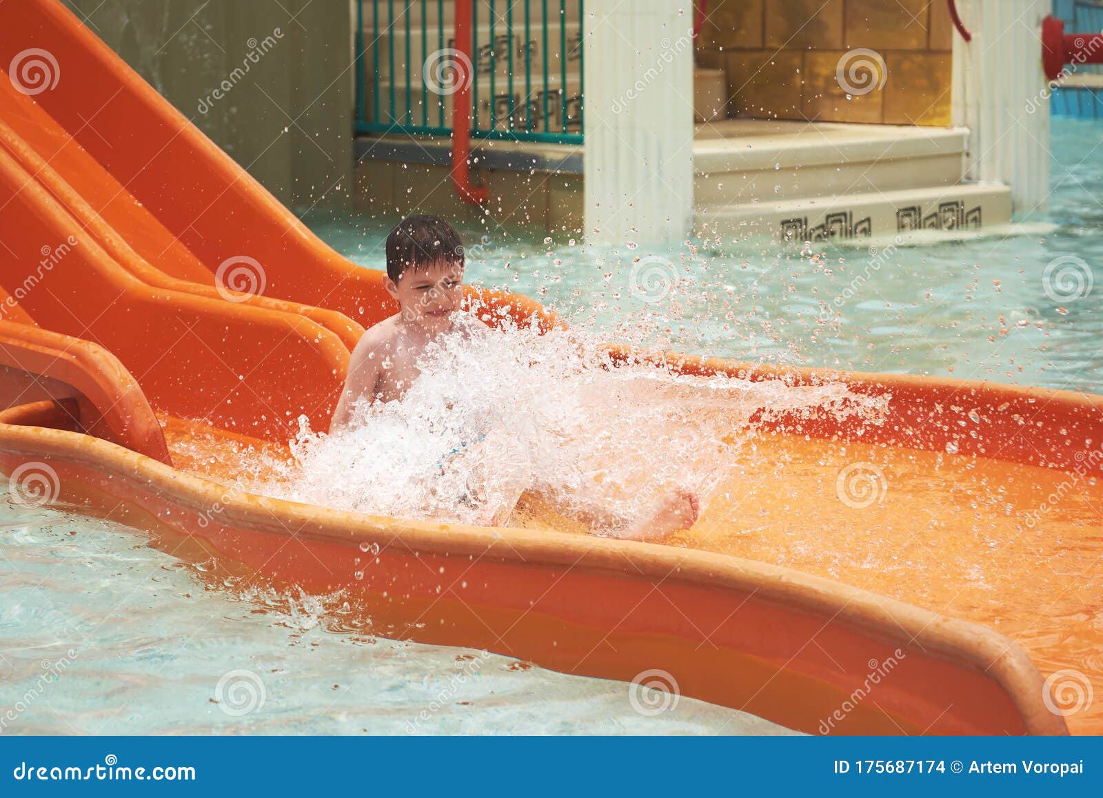 Boy Sliding Down Slide in Waterpark. Stock Photo - Image of water ...