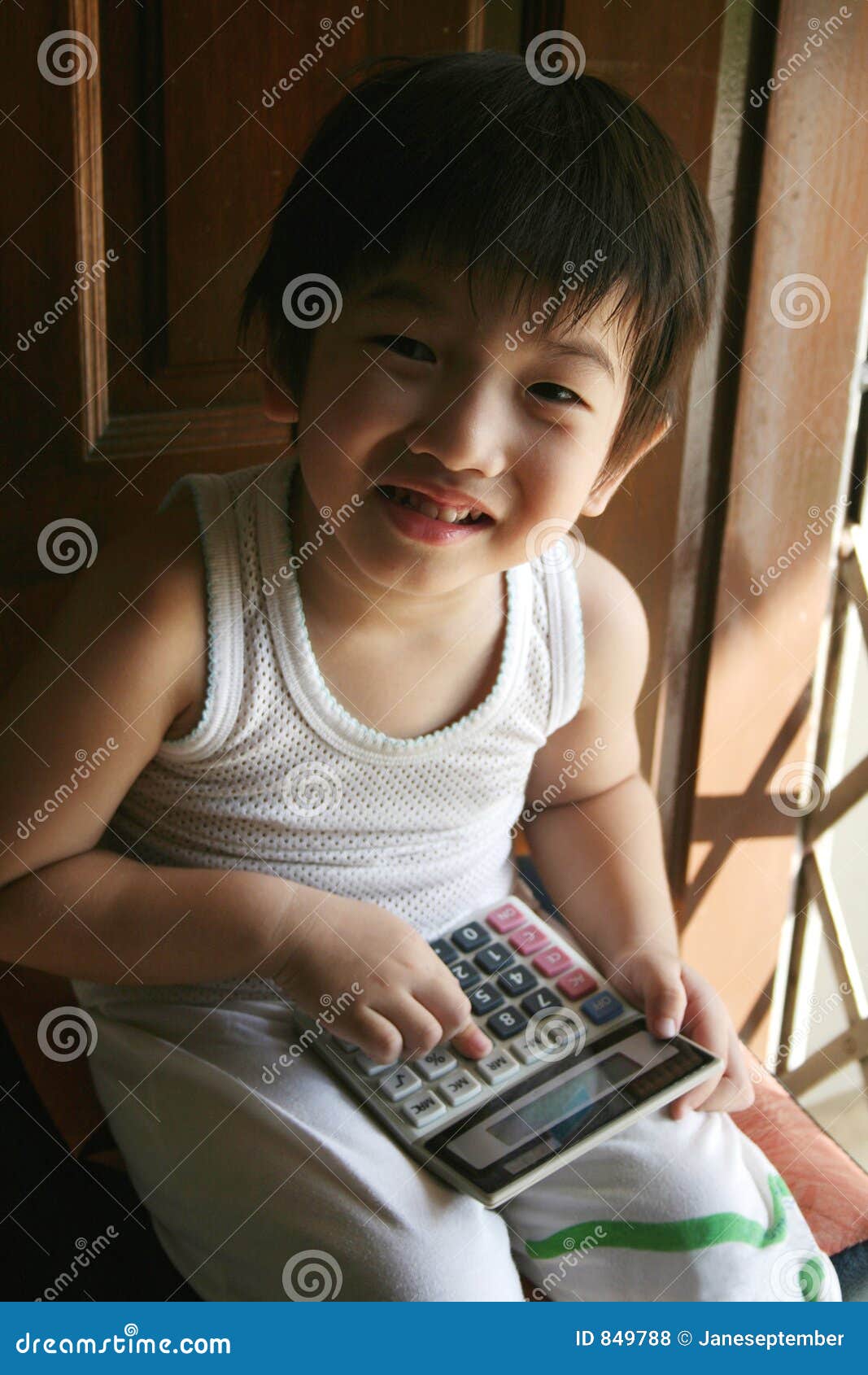 Happy boy using calculator stock photo. Image of finger - 849788