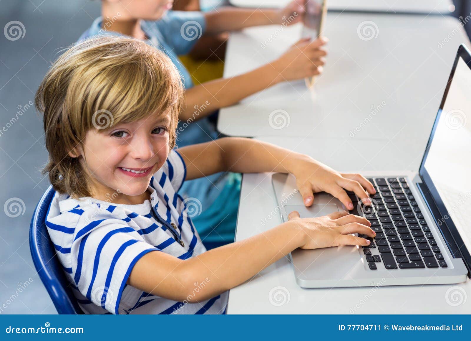 Happy boy using laptop stock image. Image of foreground - 77704711