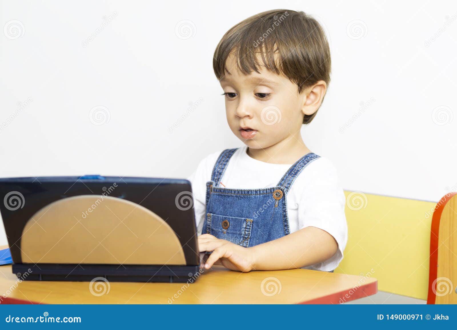 Happy Boy using laptop stock image. Image of childhood - 149000971