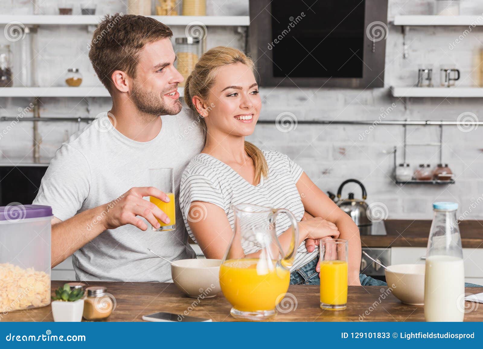 Happy Boyfriend Hugging Girlfriend during Breakfast in Kitchen and they ...