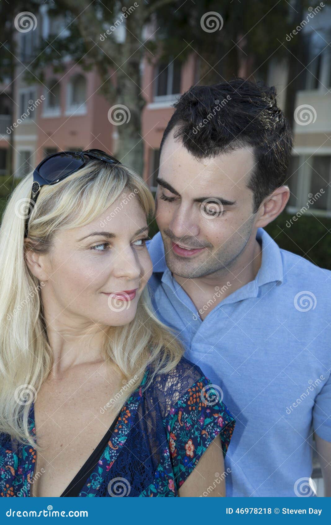 Happy Boyfriend Looking Down at His Blond Girlfriend Stock Photo ...