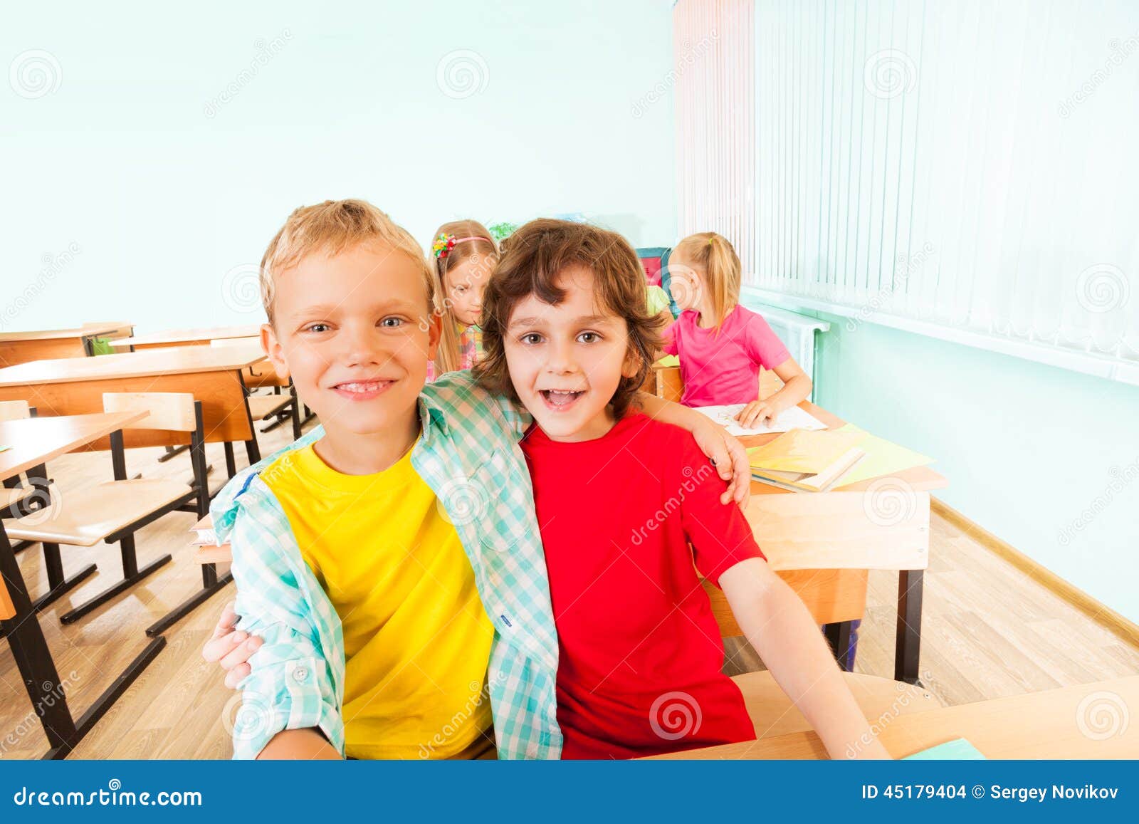 Happy Boys Hug and Sit Together in Classroom Stock Photo - Image of ...