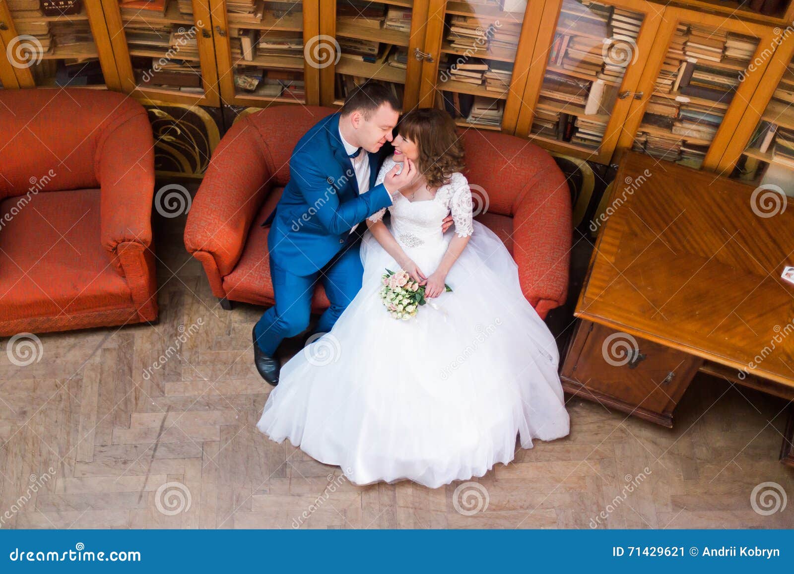 Happy Bride and Groom Resting on Red Sofa at Old Library Stock Image ...