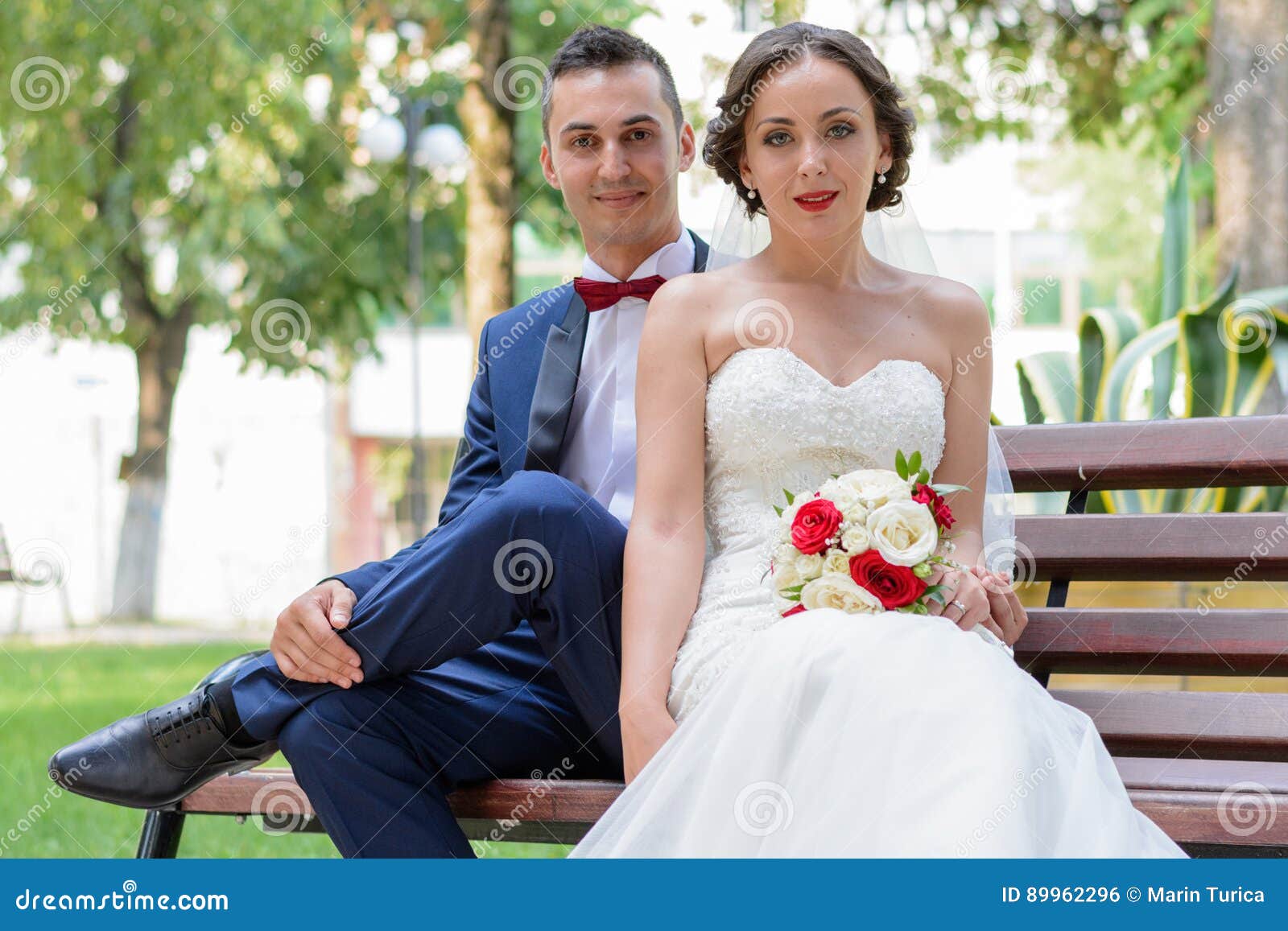 Happy Bride and Groom Sitting on Bench Stock Photo - Image of hair ...