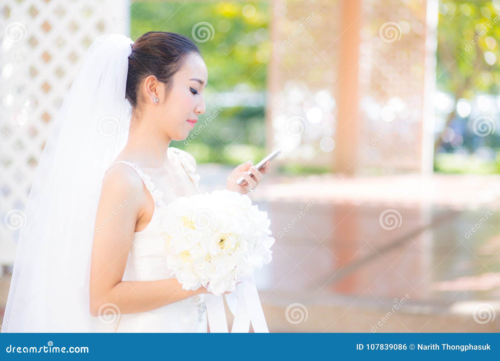 Happy Bride Talking on Cell Phone in Wedding Dress Stock Photo - Image ...