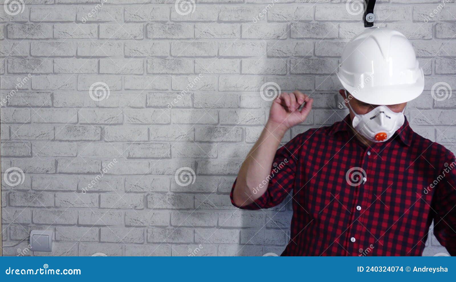 A Happy Builder on the Background of a Brick Wall is Dancing and ...