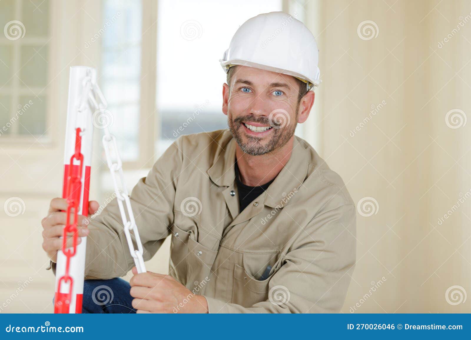 Happy Builder Holding Clipboard while Working Indoors Stock Photo ...