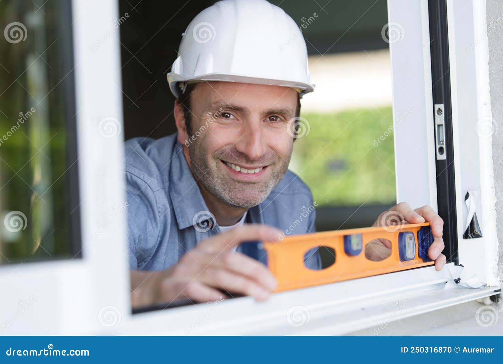 Happy Builder Posing with Spirit Level at Construction Site Stock Photo ...