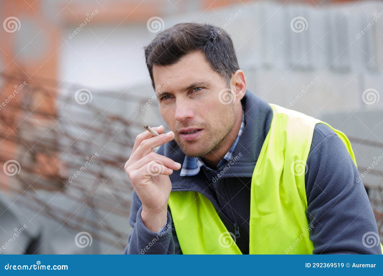 Happy Builder Smoking Cigarette on Construction Site Stock Image ...