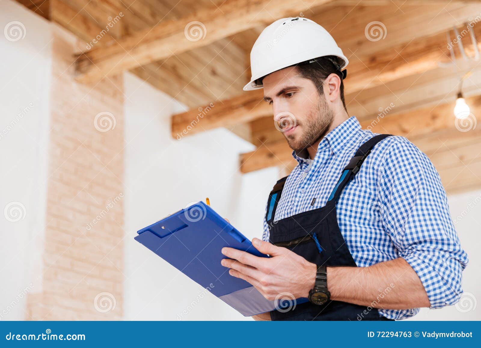 Happy Builder Writing Notes in Hardhat with Clipboard Stock Image ...