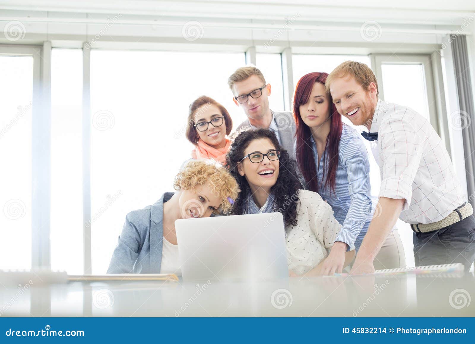 Happy Business Colleagues with Laptop Discussing in Creative Office ...
