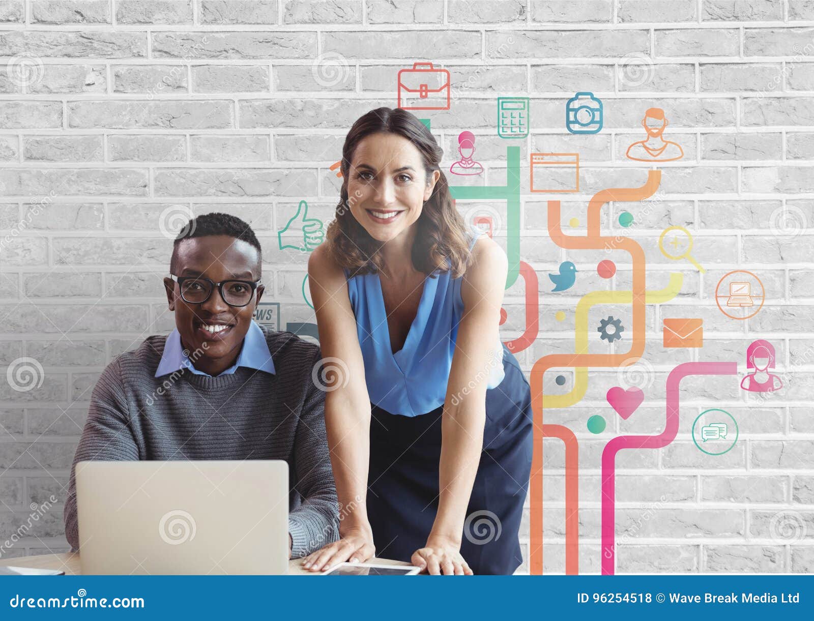 Happy Business People at a Desk Using a Computer Against White Wall ...