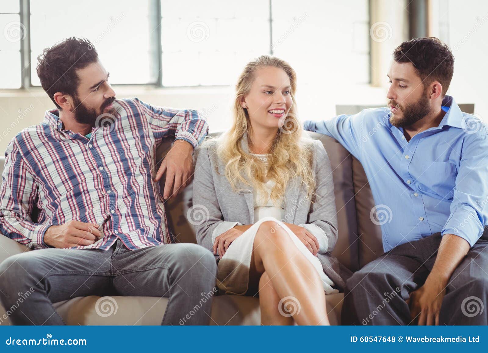 Happy Business People Discussing while Sitting on Sofa Stock Photo ...