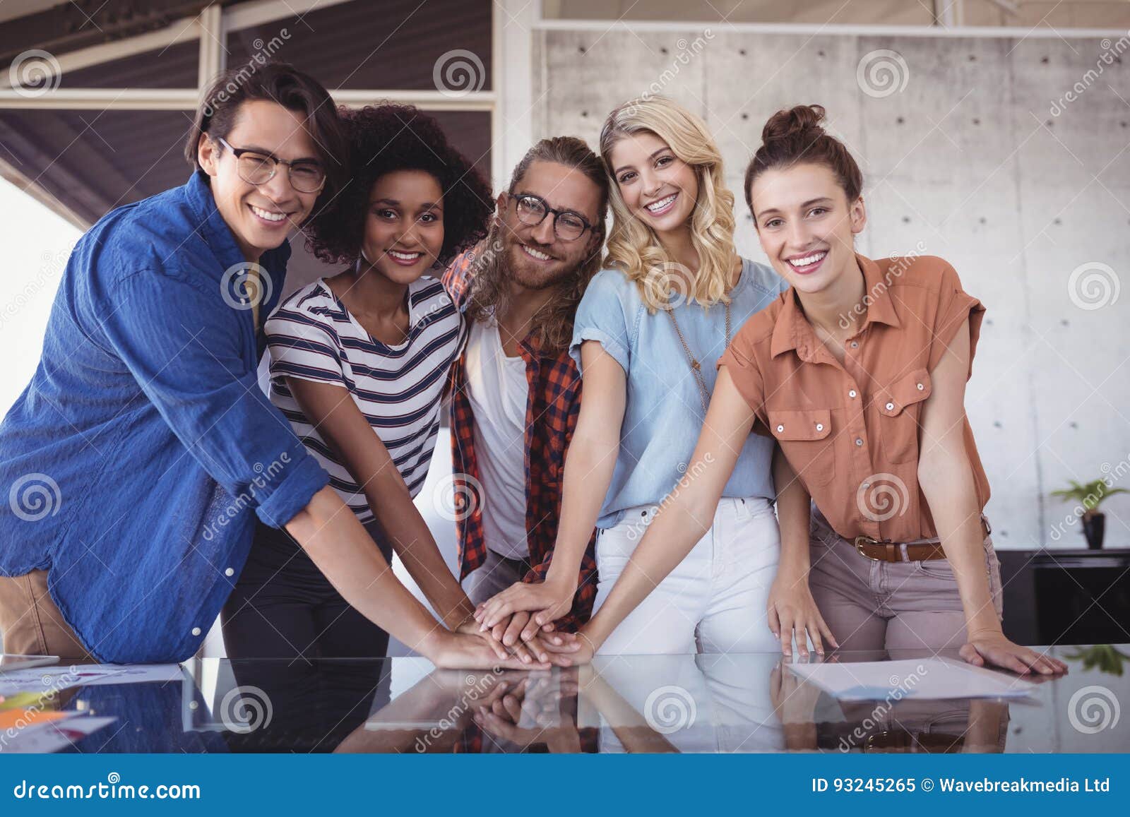 Happy Business People Stacking Hands on Table in Creative Office Stock ...