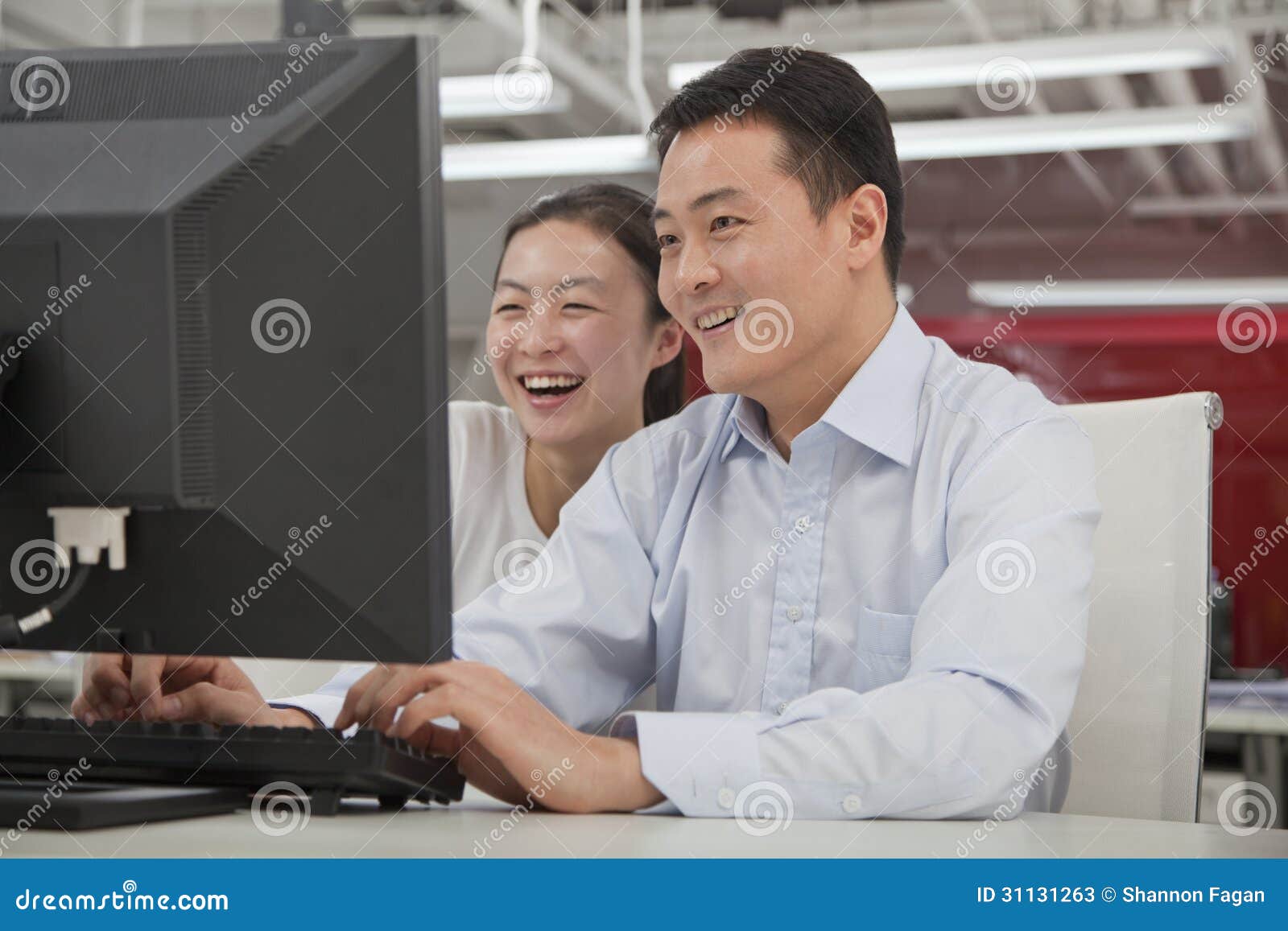 Happy Business People Working on Their Computer in the Office Stock ...