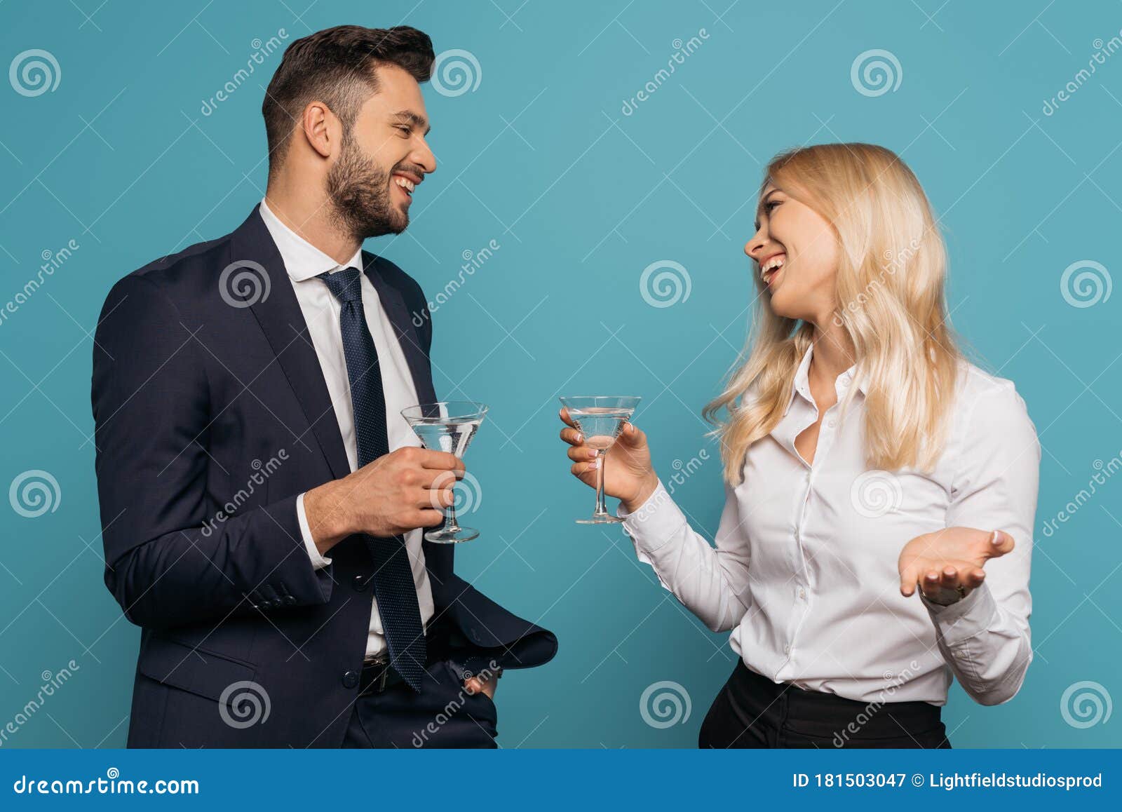 Happy Businessman And Businesswoman Holding Cocktail Glasses While