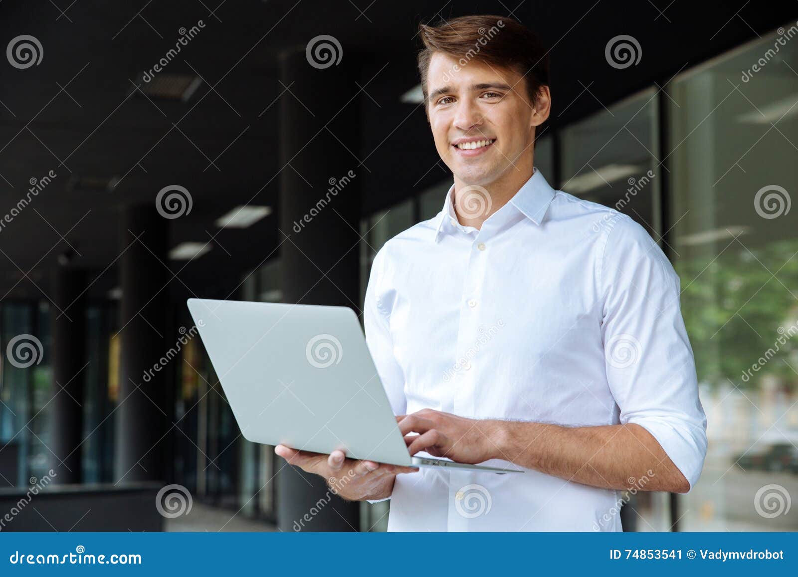 Happy Businessman Holding and Using Laptop Stock Image - Image of ...