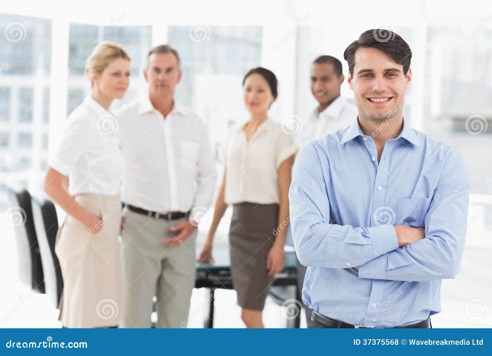 Happy Businessman Standing with Team Behind Him Stock Photo - Image of ...