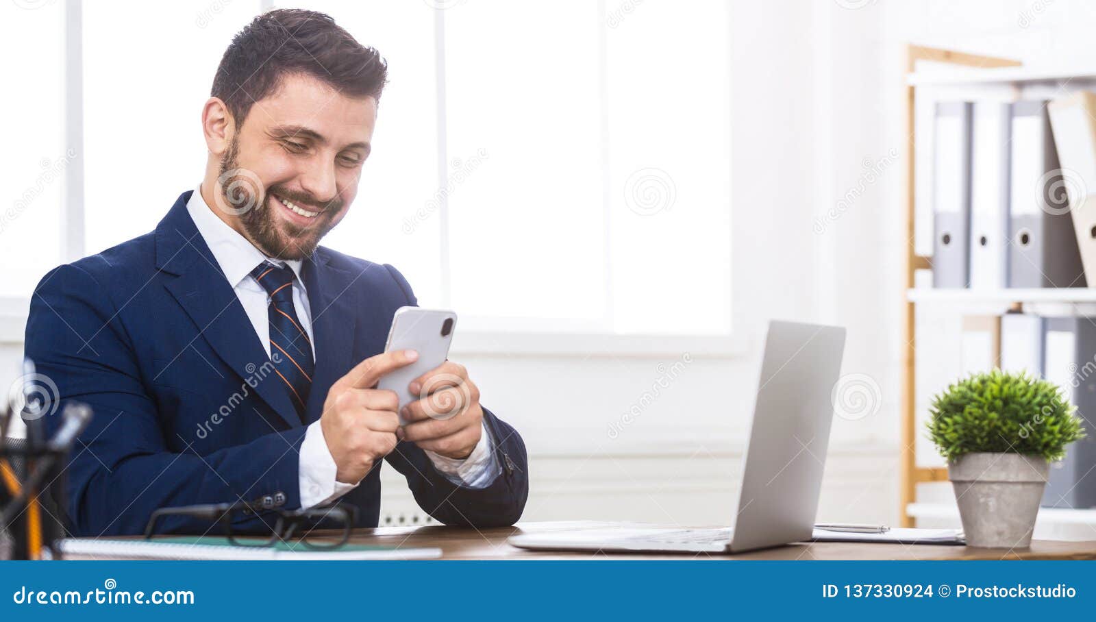 Happy Businessman Surfing Internet on Smartphone in Office Stock Photo ...