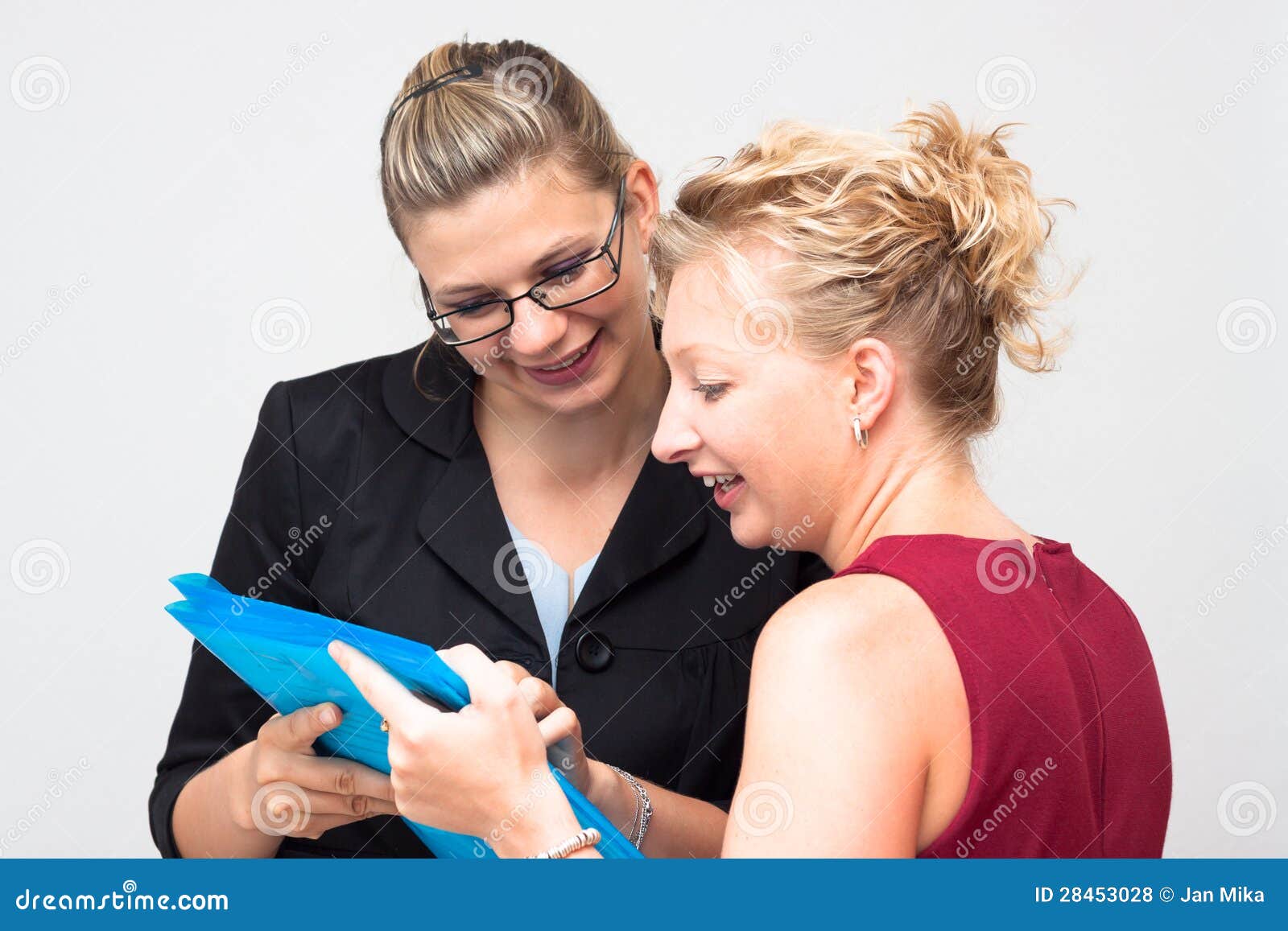 Happy Businesswomen Looking at Document Stock Photo - Image of ...