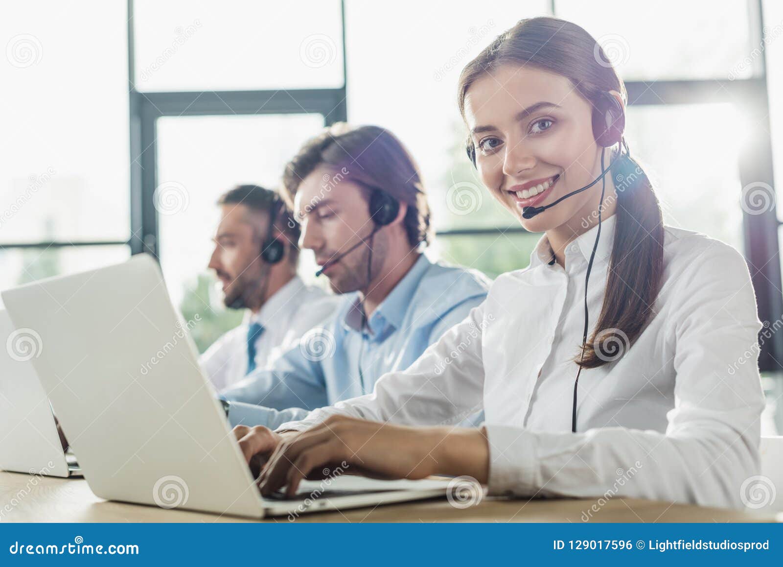 Happy Call Center Managers Working with Laptops and Microphones Stock ...