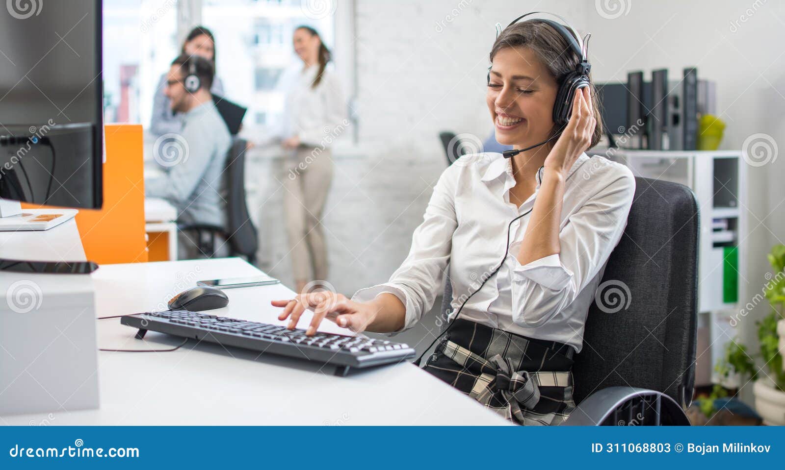 Happy Call Center Operator Talking with Client at Company Office. Stock ...