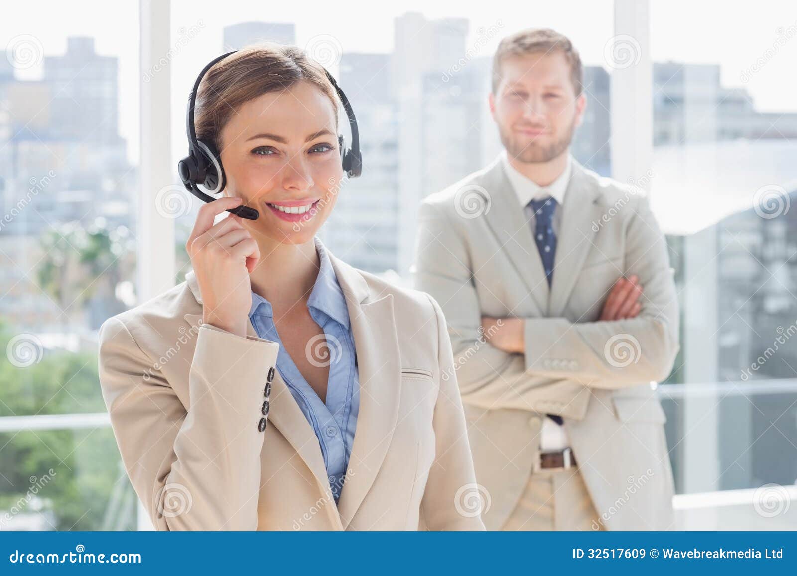 Happy Call Centre Agent with Colleague Behind Her Stock Image - Image ...