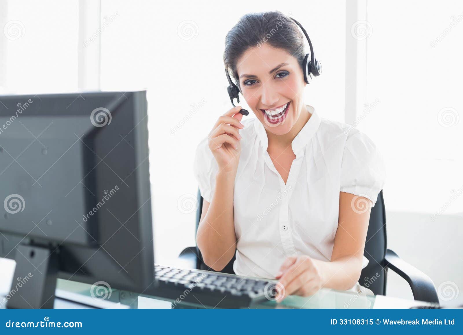 Happy Call Centre Agent Sitting at Her Desk on a Call Stock Image ...