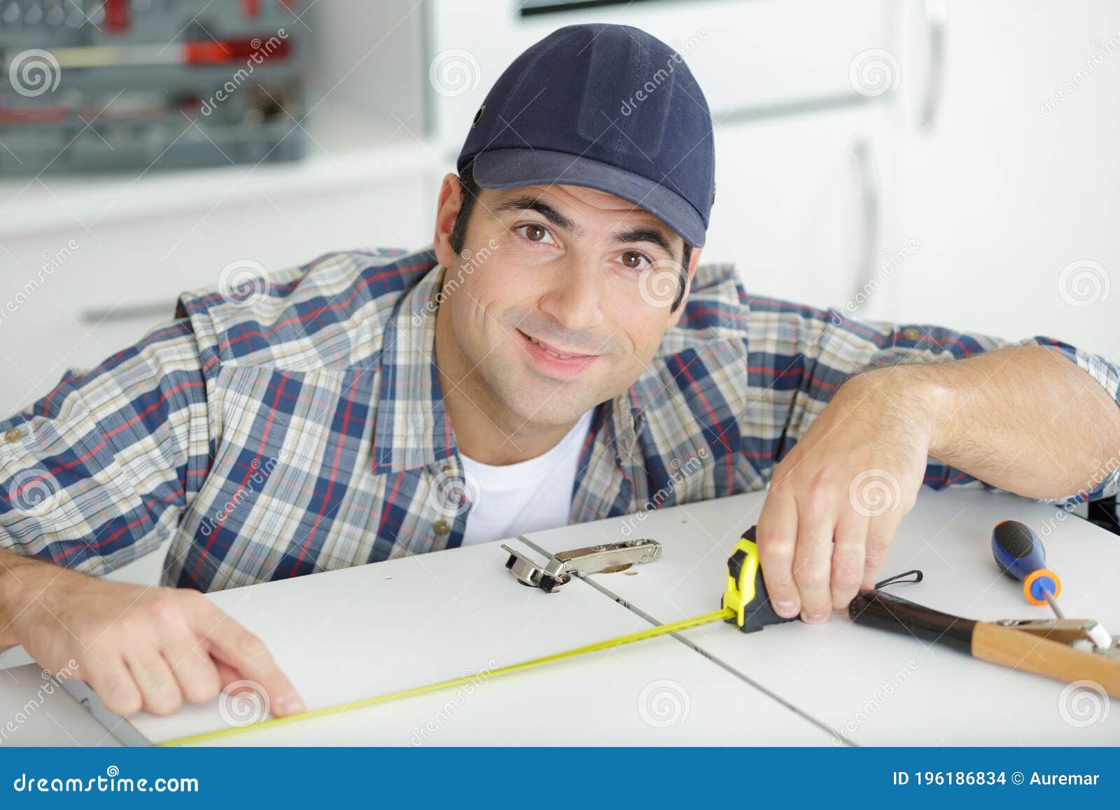 Happy Carpenter while Measuring Wood at Construction Site Stock Photo ...