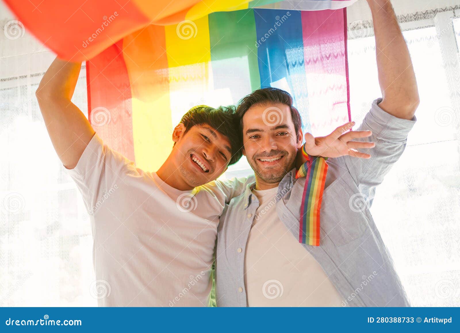 Happy Caucasian And Asian Lgbt Couple Standing And Waving Under The
