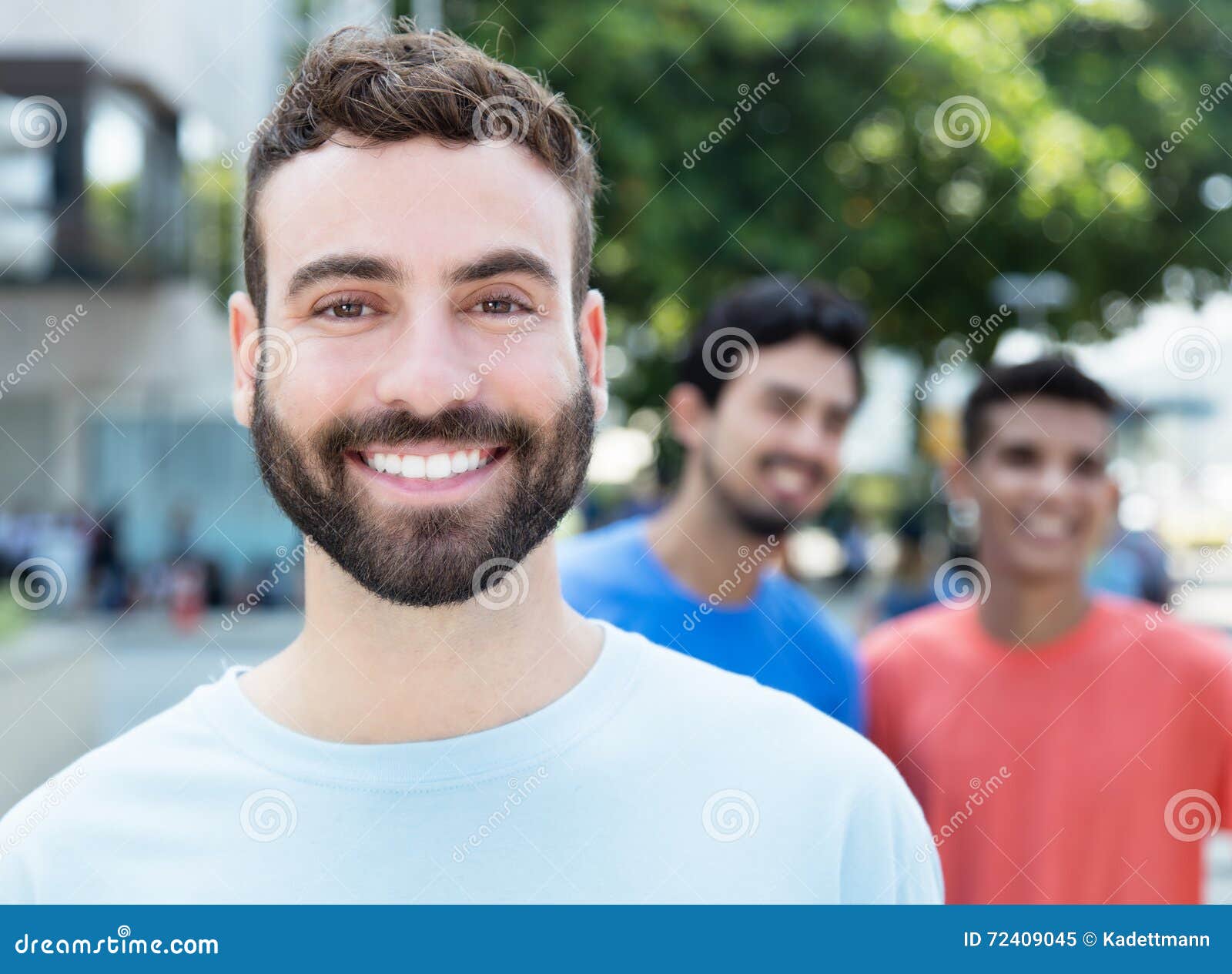 Happy Caucasian Man With Beard With Two Friends In The City Stock Image