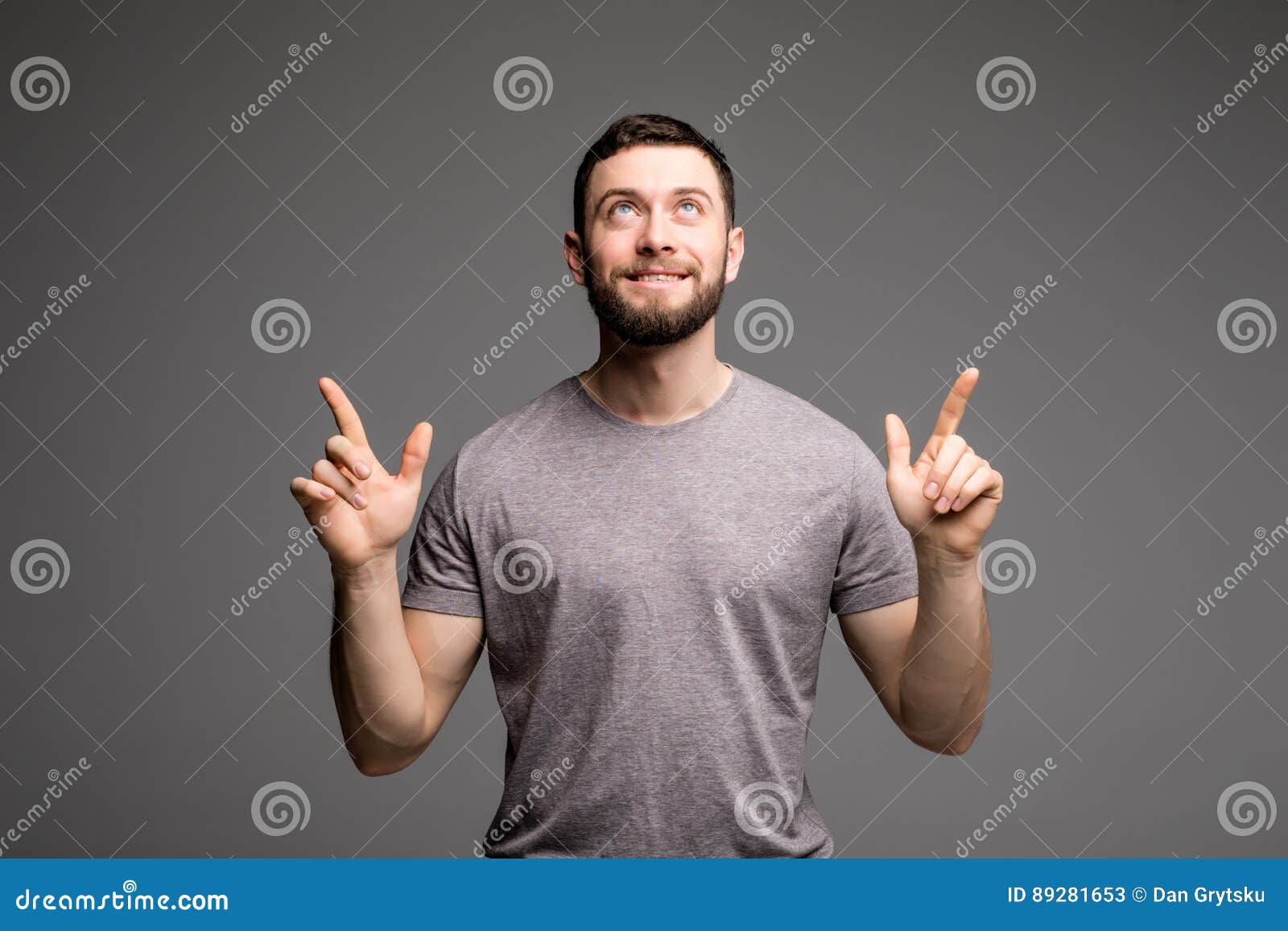 Happy Cheerful Young Guy Gesturing Up with Fingers on Grey Stock Image ...