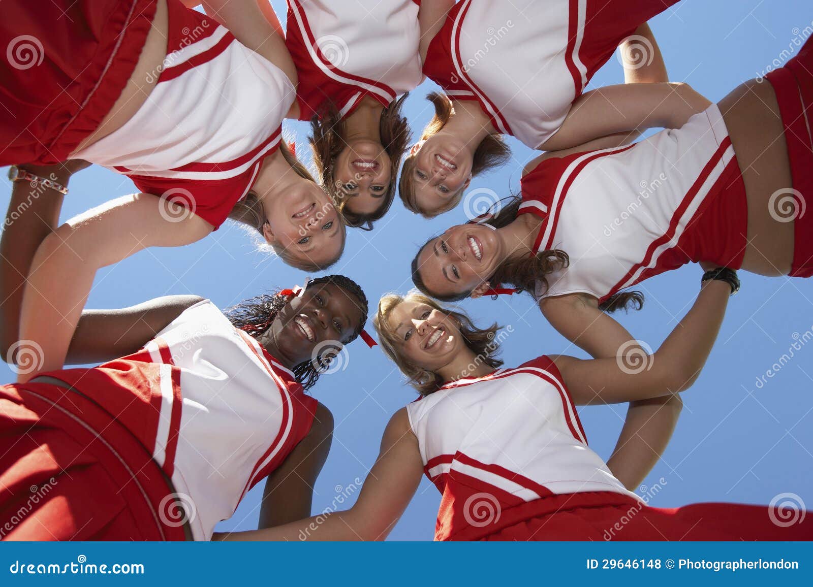 Happy Cheerleaders Forming a Huddle Stock Photo - Image of huddle ...