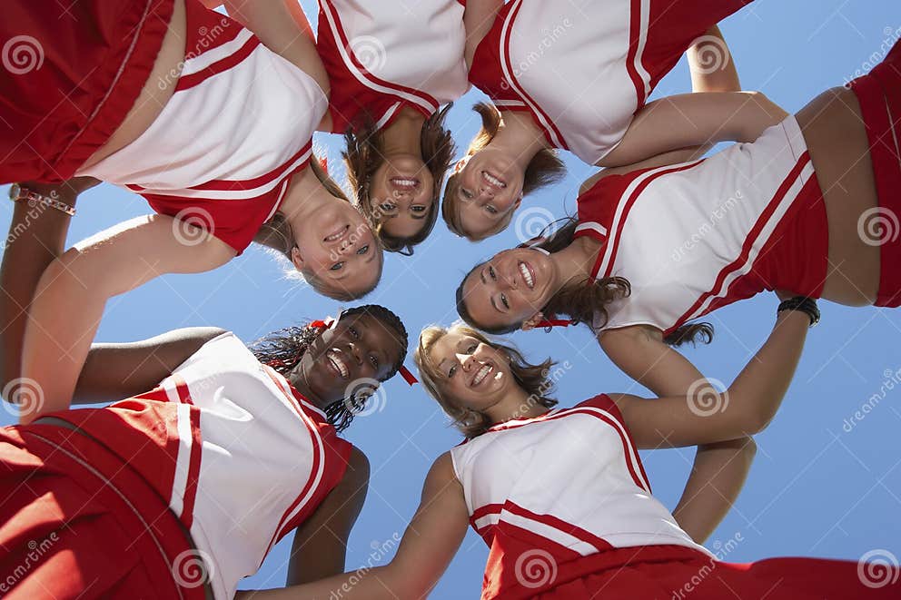 Happy Cheerleaders Forming a Huddle Stock Photo - Image of huddle ...
