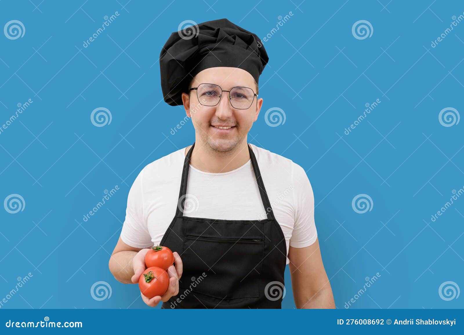 Happy Chef with Tomatoes in His Hand Looking at the Camera on a Blue ...