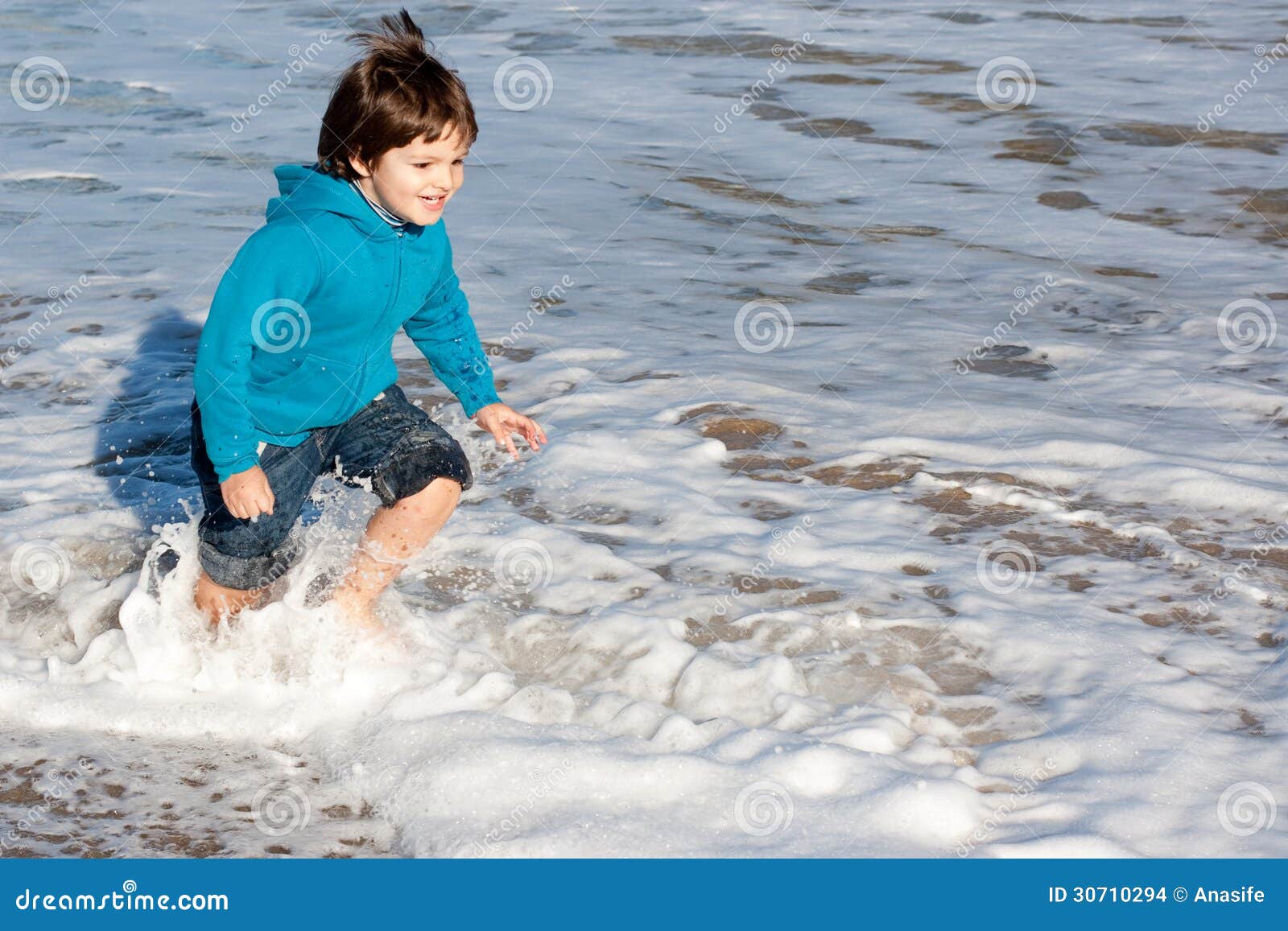 Happy Child Caught by Waves Stock Photo - Image of contact, jump: 30710294